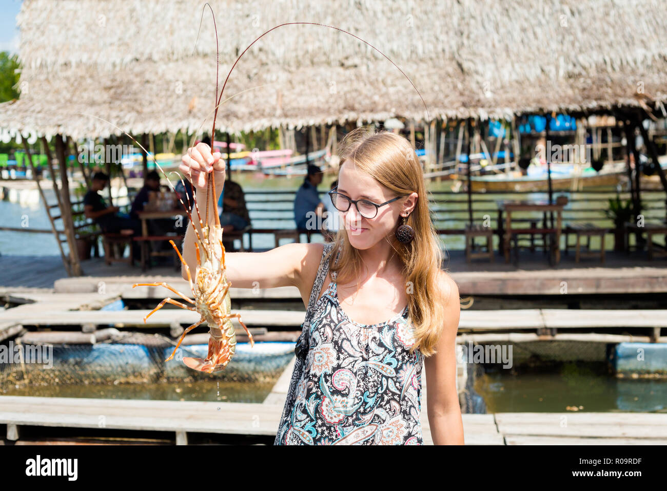 Tourist holding big lobster on tropical Koh Klang island in Krabi in ...