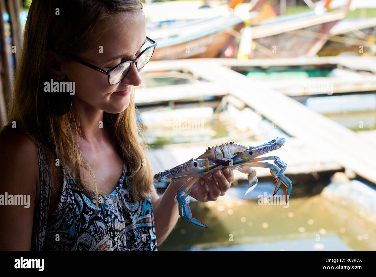 Tourist holding blue crab on tropical Koh Klang island in Krabi in ...