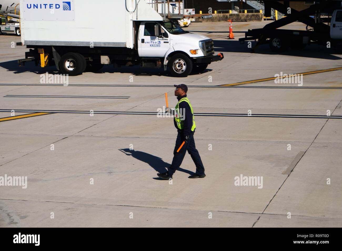 Airport marshaller ready to direct airplane on tarmac before take-off ...