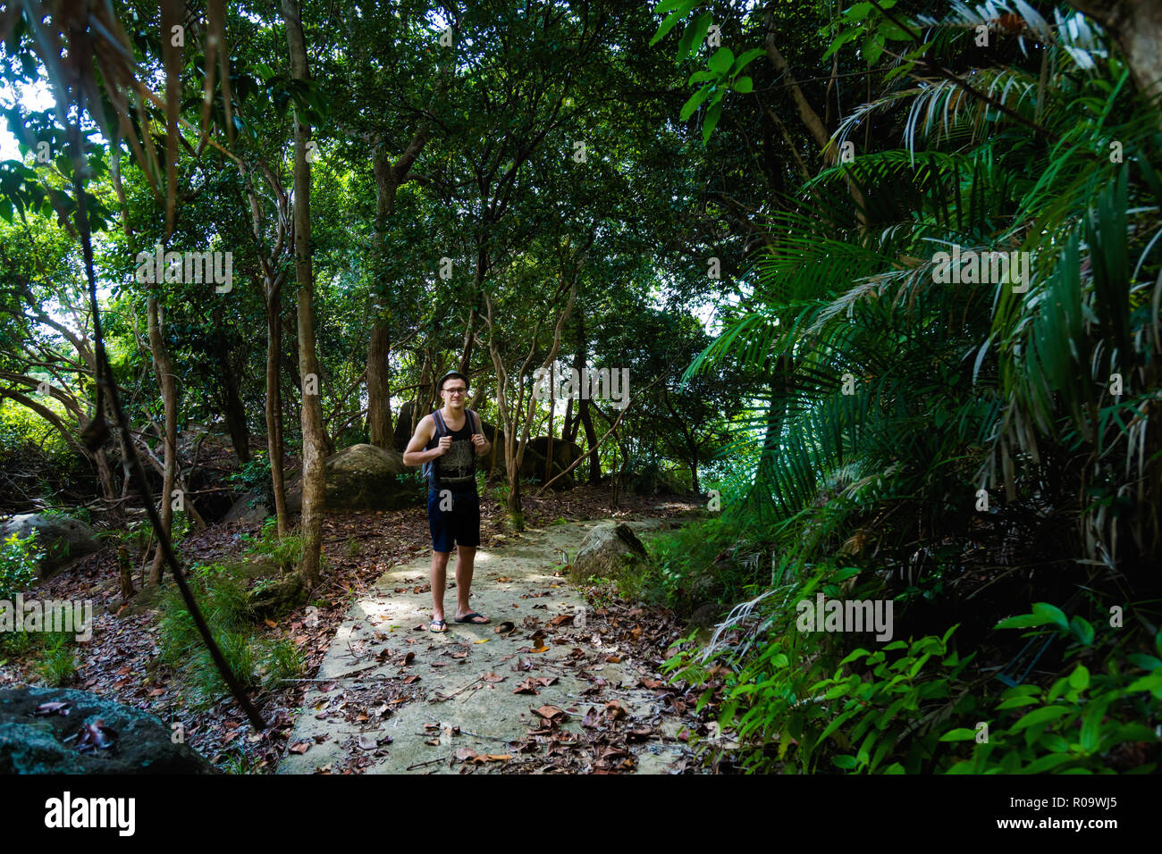 Young tourist having jungle trekking on tropical Tioman island in ...
