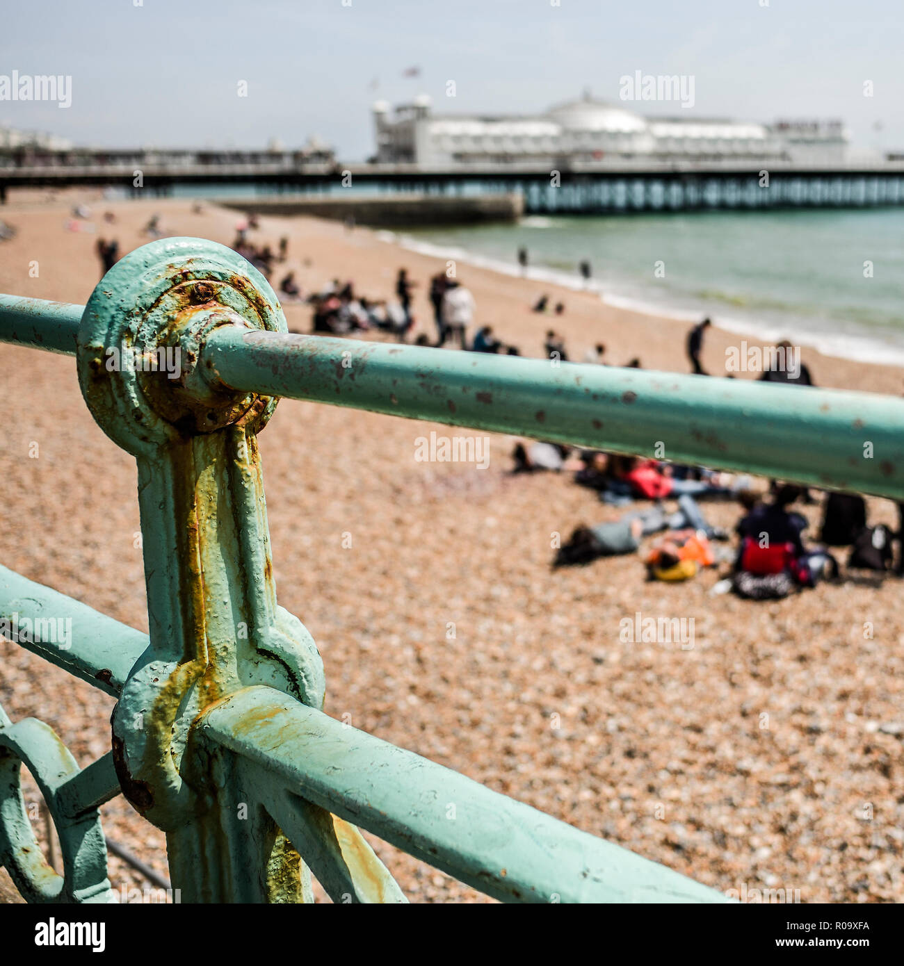 Empty table and chairs overlooking beach sceene on stone beach Brighton ...