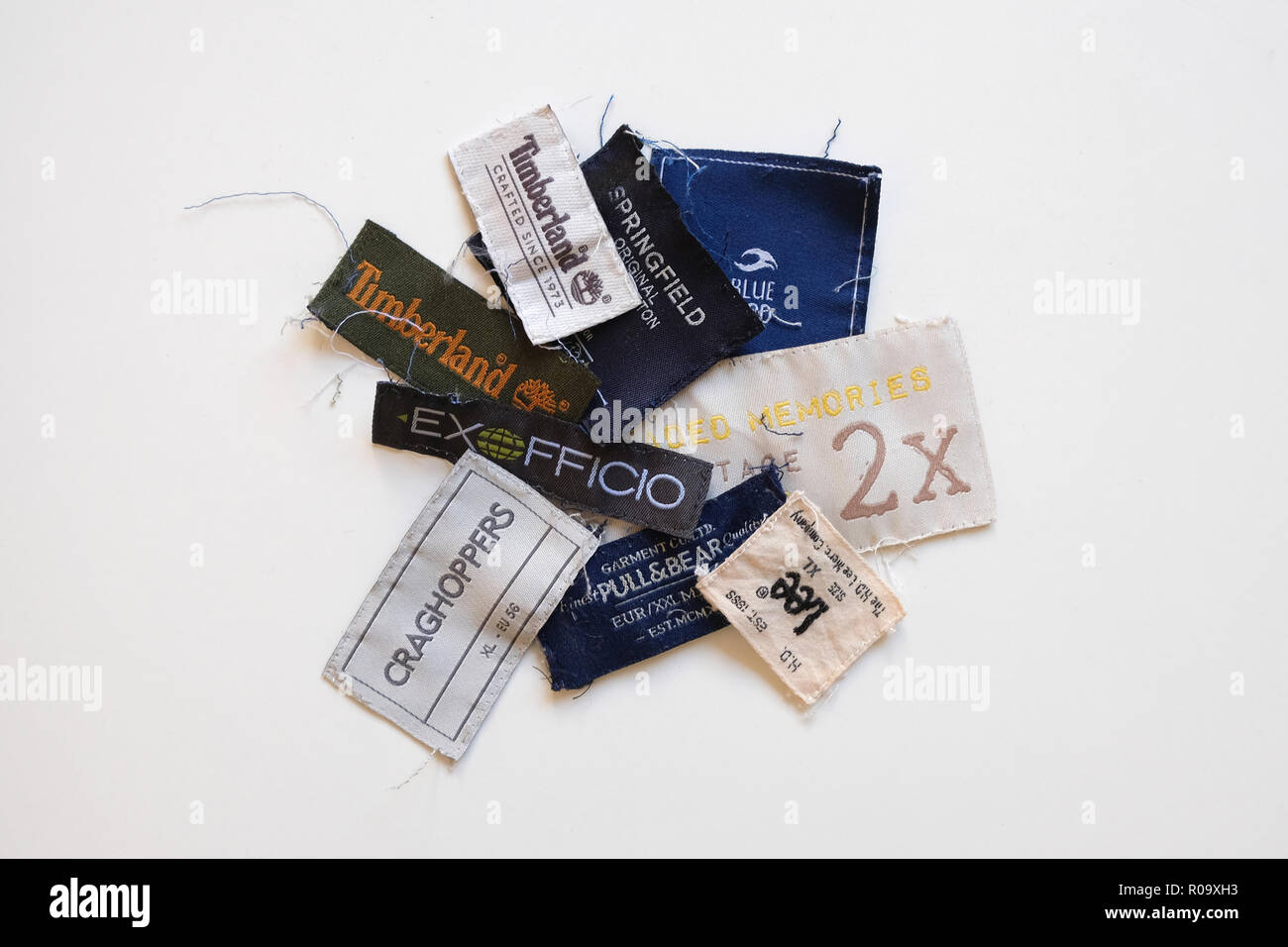 Stack of removed clothing labels Stock Photo - Alamy