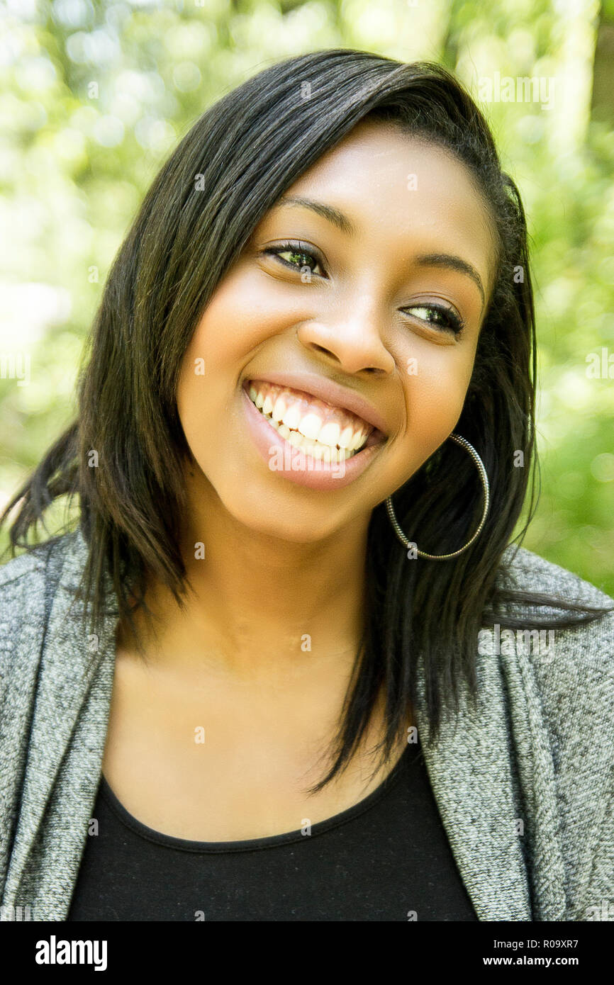 woman smiling while looking away Stock Photo - Alamy