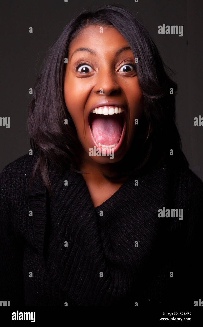 Young woman screaming with mouth wide open Stock Photo - Alamy