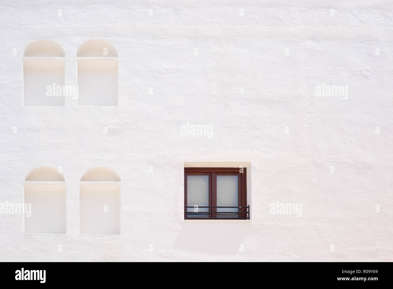 White wall with one window and four niches Stock Photo - Alamy