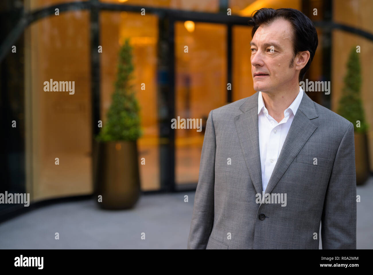 Mature handsome businessman exploring around the city Stock Photo - Alamy