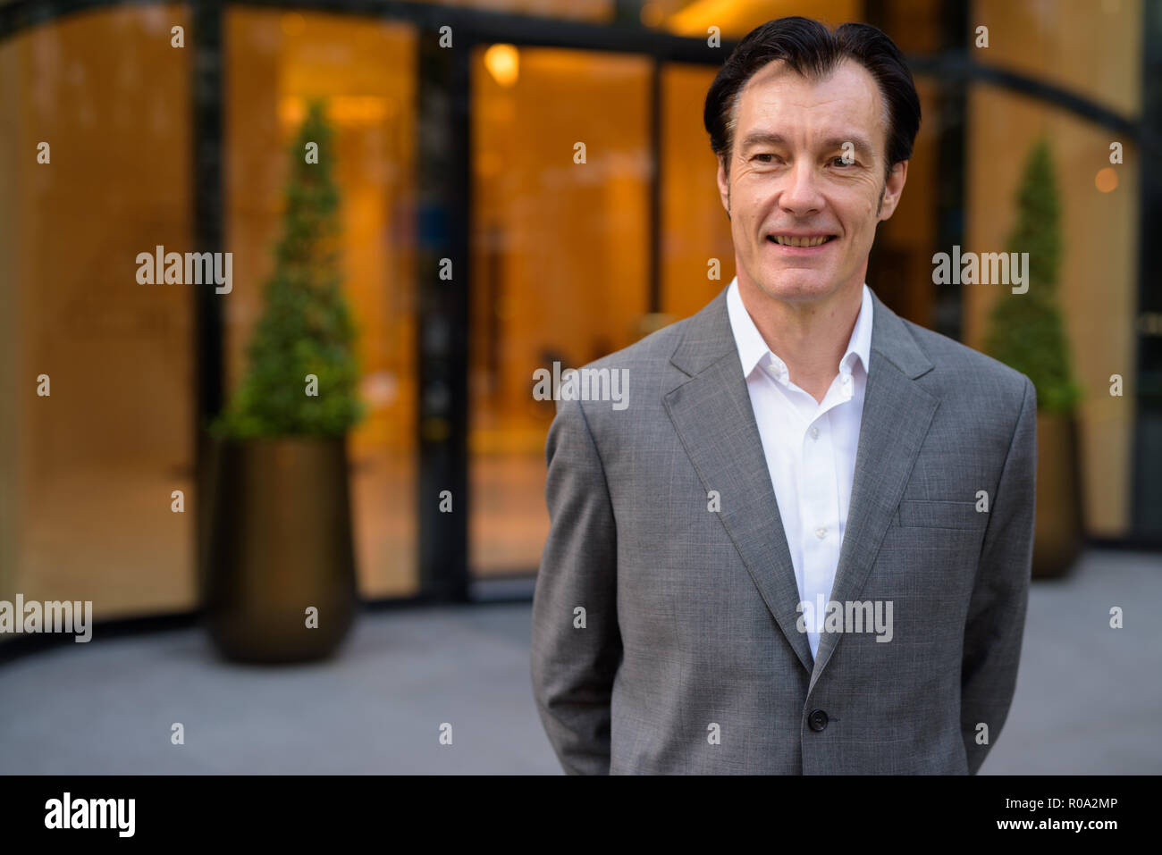 Mature handsome businessman exploring around the city Stock Photo - Alamy
