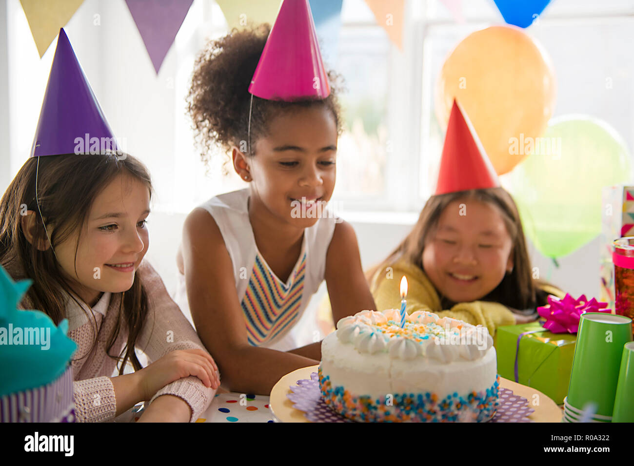 A Group of three adorable kids having fun at birthday party Stock Photo ...