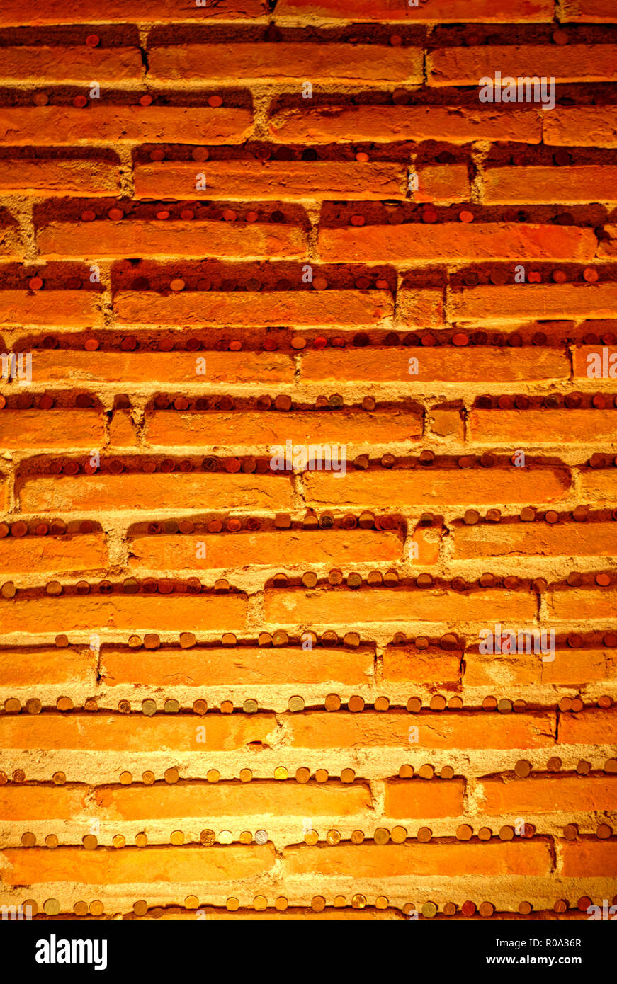 Brick wall background with coins on the bricks closeup view Stock Photo ...