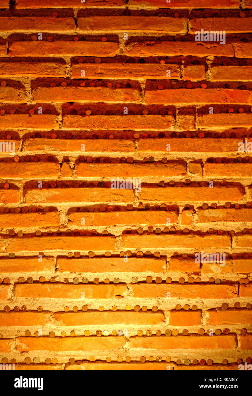 Brick wall background with coins on the bricks closeup view Stock Photo ...