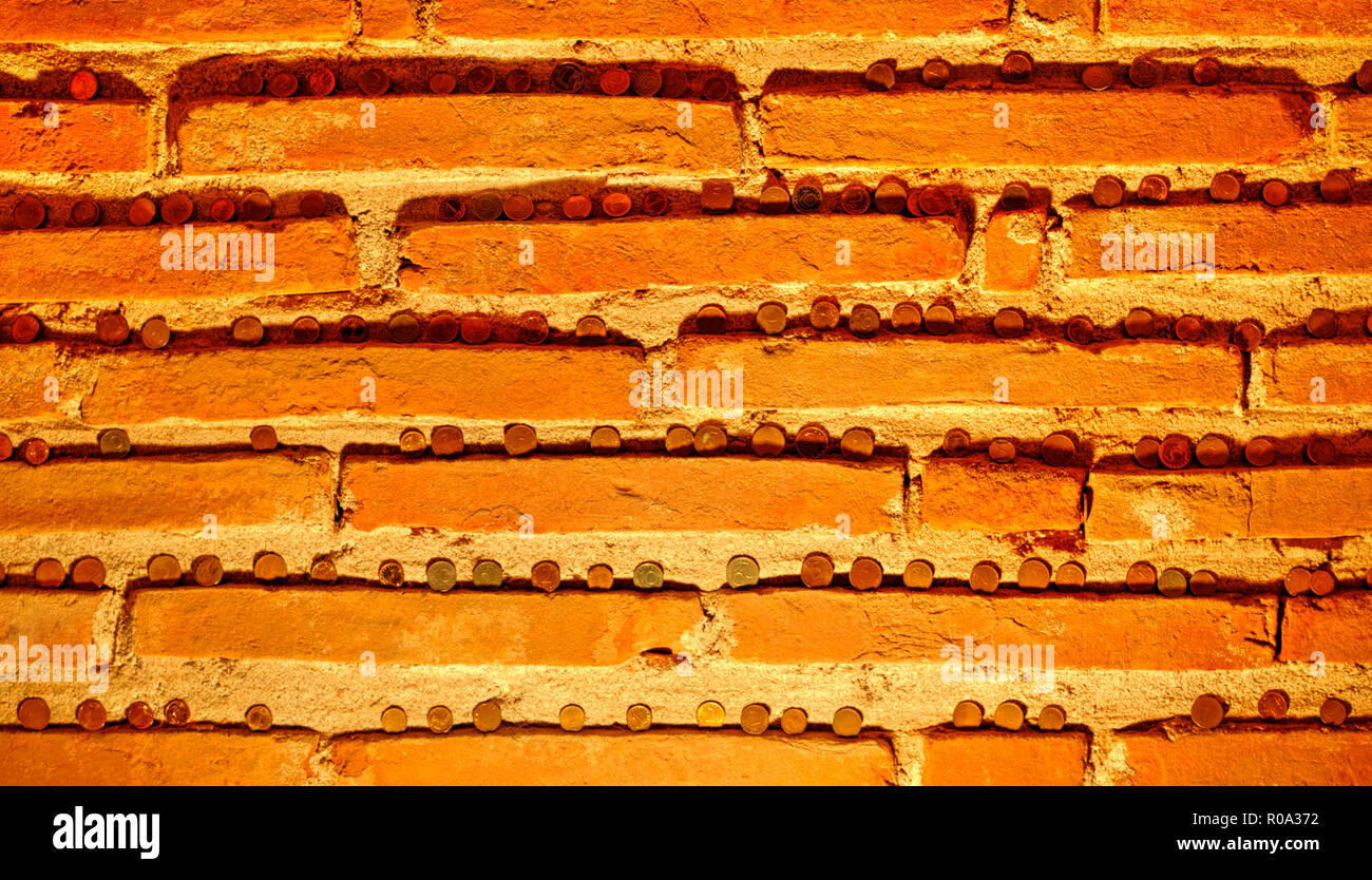 Brick wall background with coins on the bricks closeup view Stock Photo ...