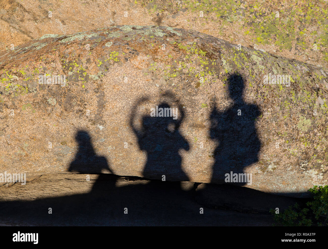 Shadows of happy people on the rocks Stock Photo - Alamy