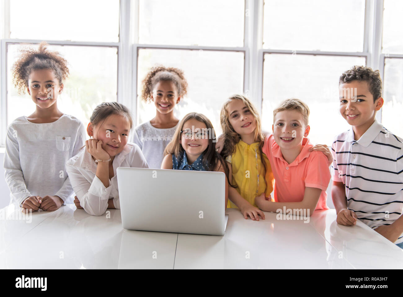 A Group of curious children watching stuff on the laptop screen Stock ...