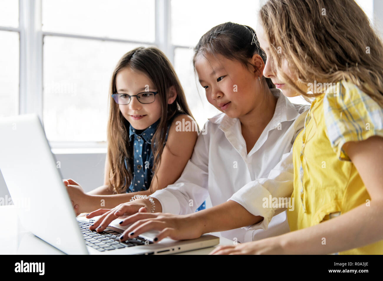 A Group of curious children watching stuff on the laptop screen Stock ...
