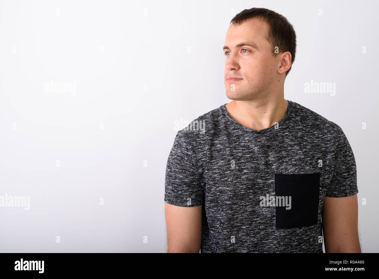 Studio shot of young muscular man thinking while looking at dist Stock ...