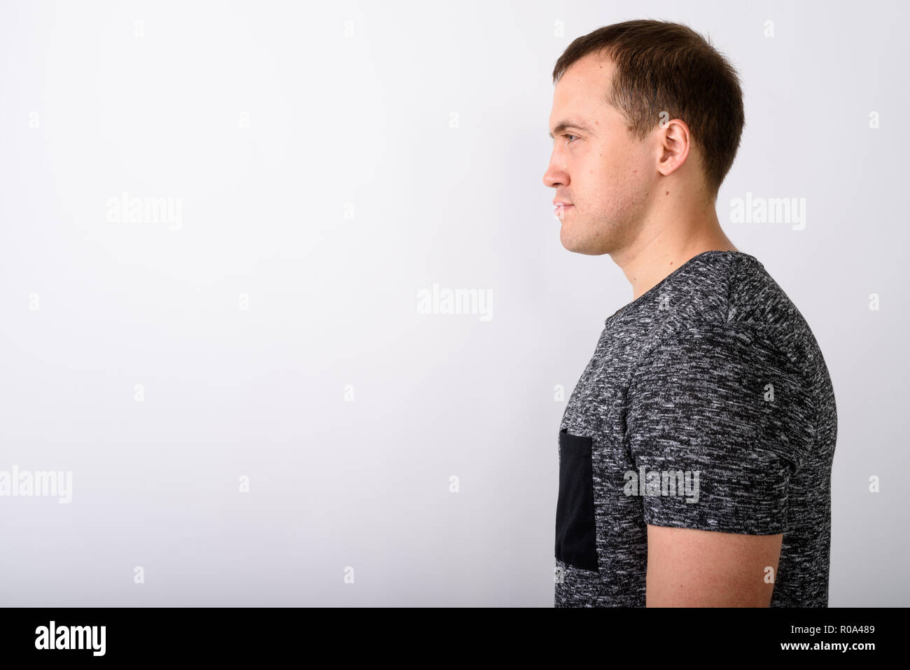 Profile view portrait of young muscular man standing Stock Photo - Alamy