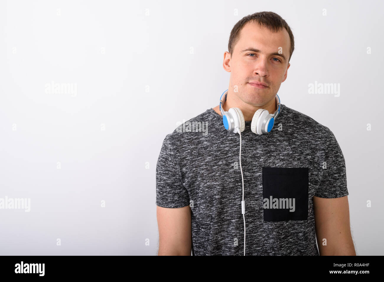 Studio shot of young muscular man wearing headphones around neck Stock ...