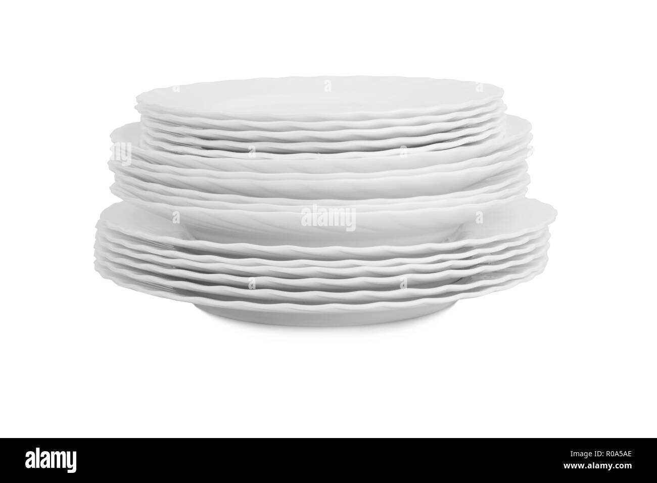 pile of white plates on a white background Stock Photo - Alamy