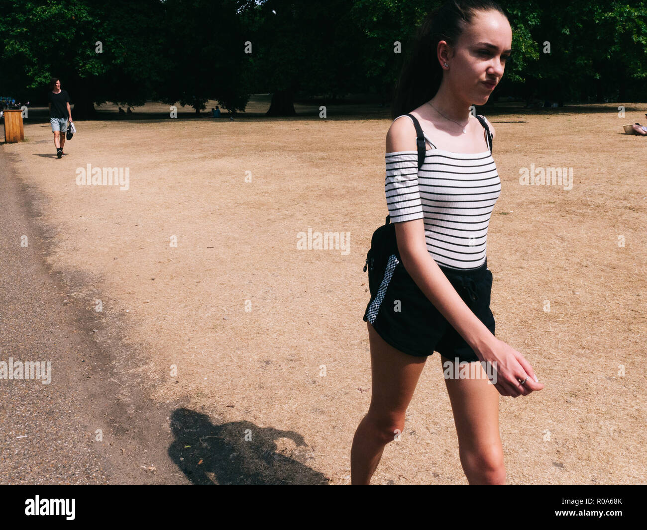 White girl student teen in shorts walking in the park in London Stock ...