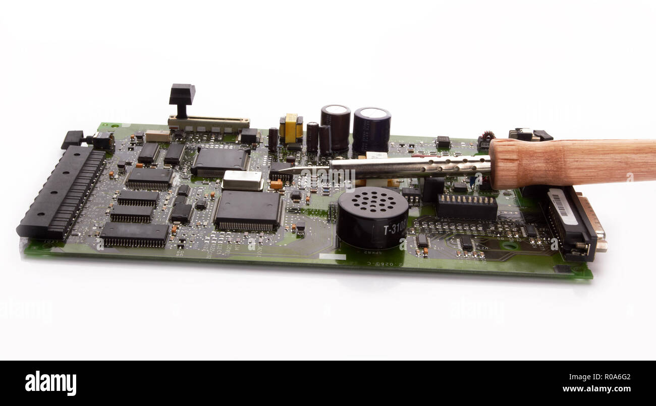 computer micro circuit board with iron soldering and tin wire in ...