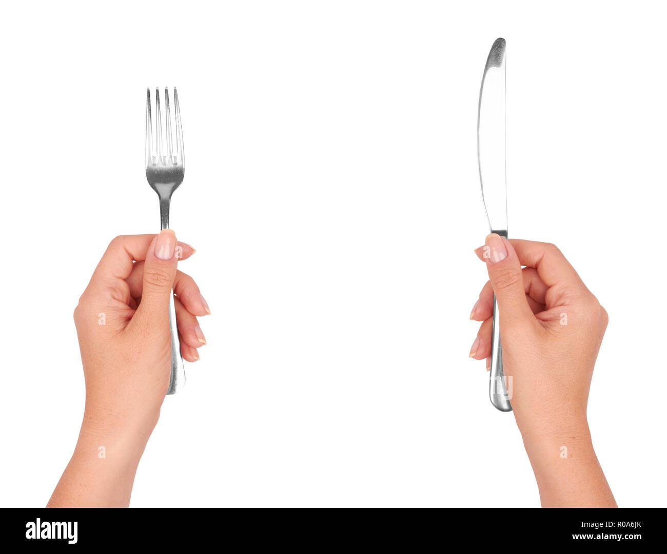 A knife and fork in womans hands. Isolated on white Stock Photo - Alamy