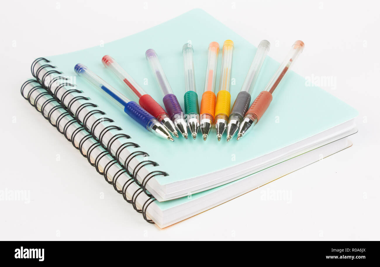 Notebook and pens on white background Stock Photo - Alamy