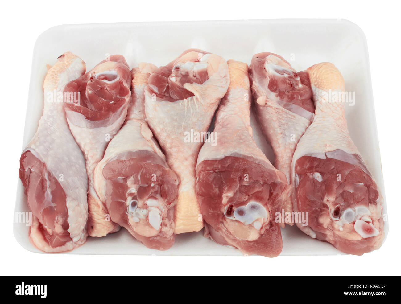 chicken legs on plastic plate isolated on white background Stock Photo ...