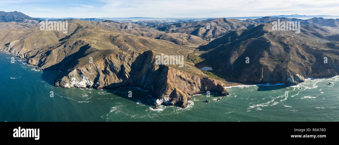 The cold water of the Pacific Ocean washes onto the scenic and rugged ...