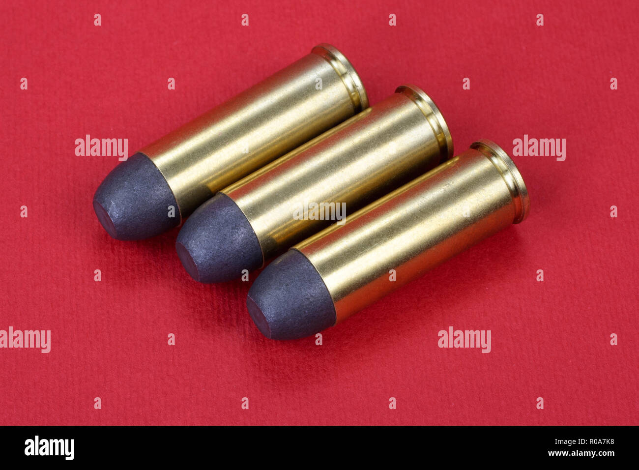 Black-powder revolver rounds .45 cal. dating to 1872 on red background ...