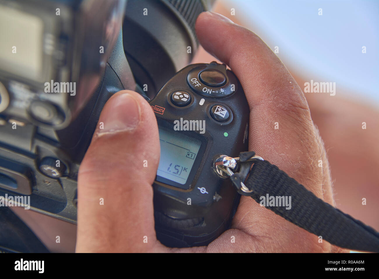 Hand holding the camera close with the finger ready to press the ...