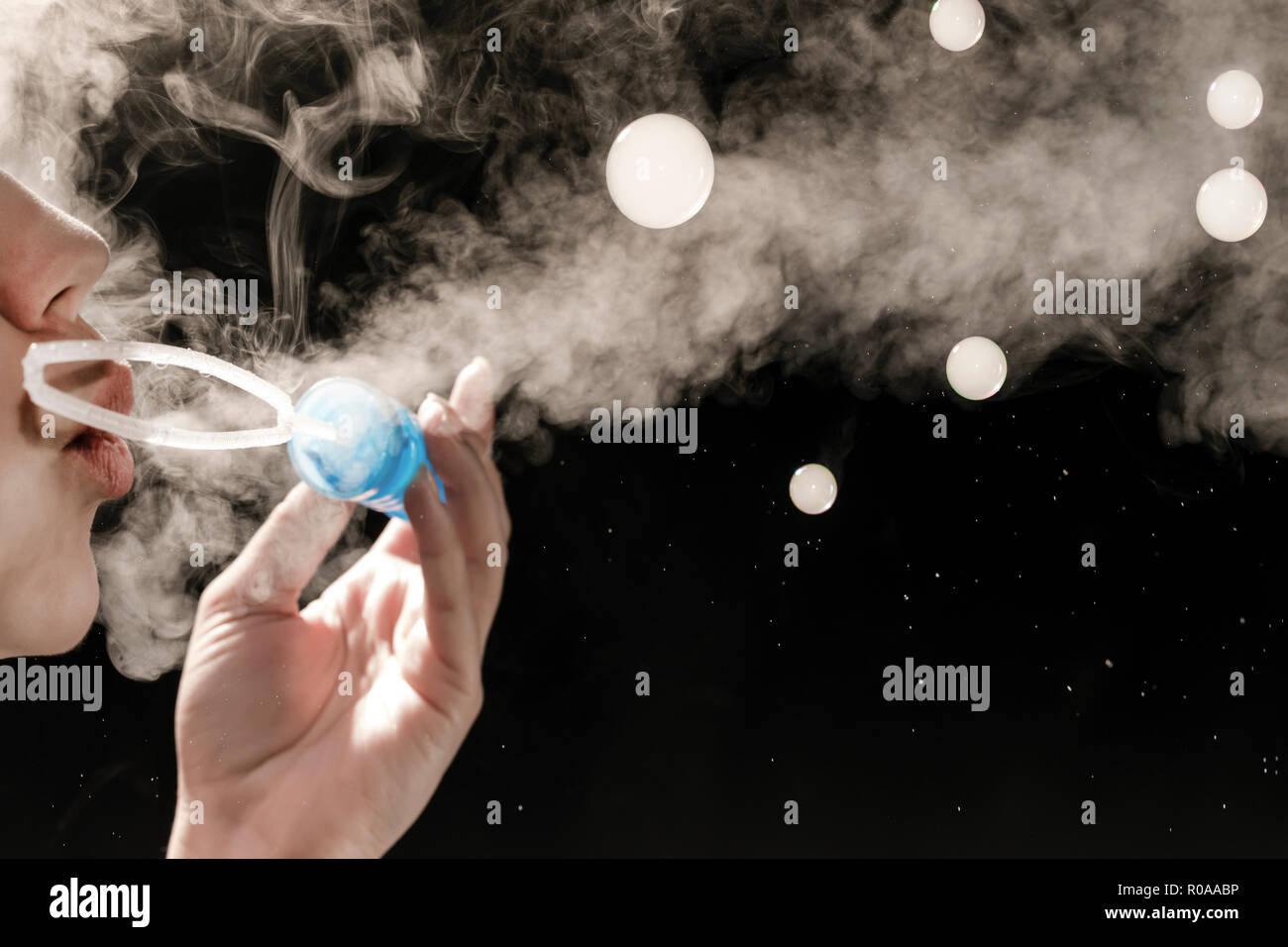 Beautiful girl blowing smoke soap hi-res stock photography and images ...