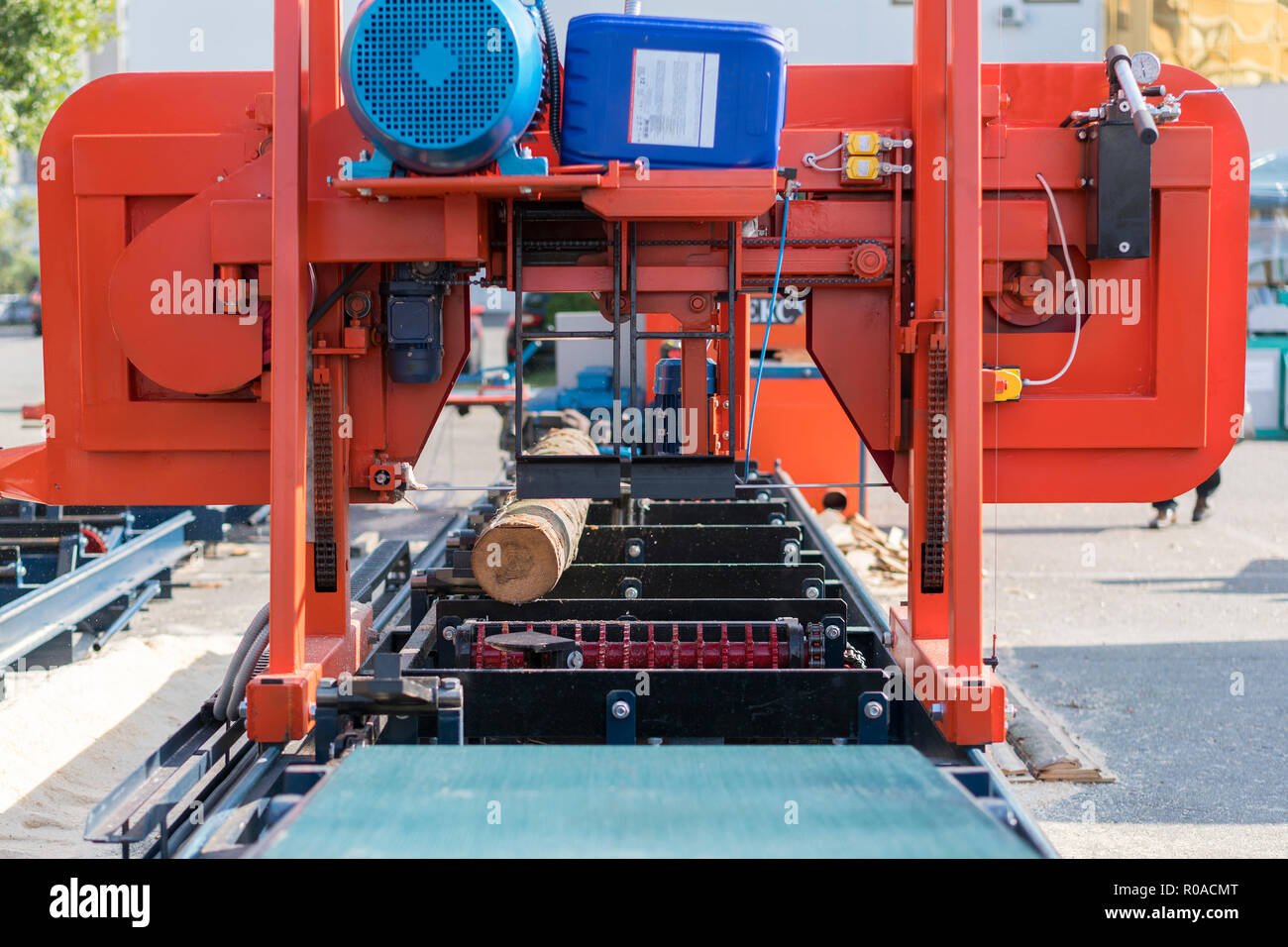 woodworking enterprise. Wood Cutting Machine. Partially milled log on a ...