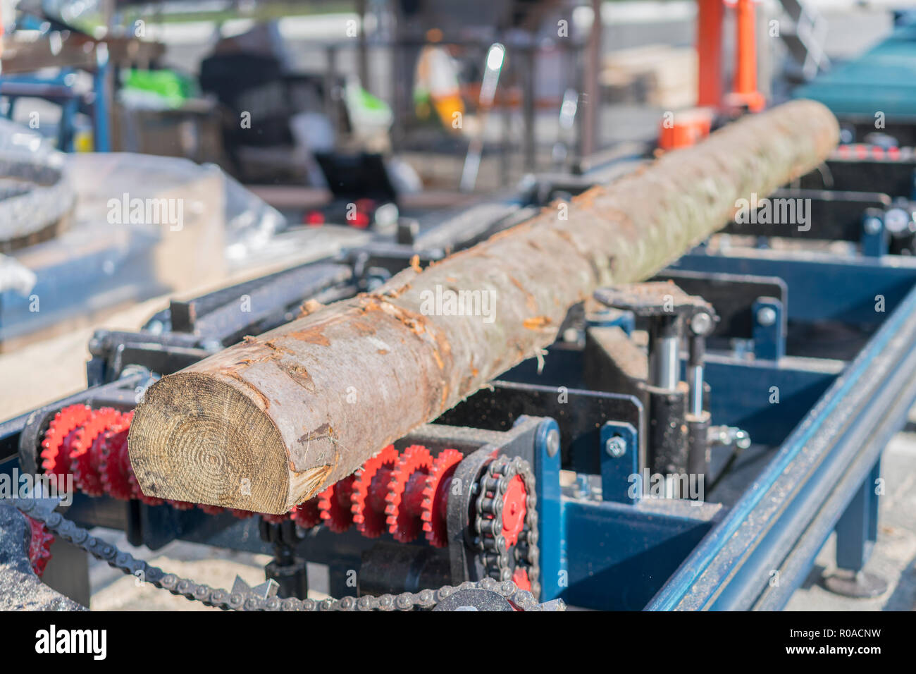 woodworking enterprise. Wood Cutting Machine. Partially milled log on a ...