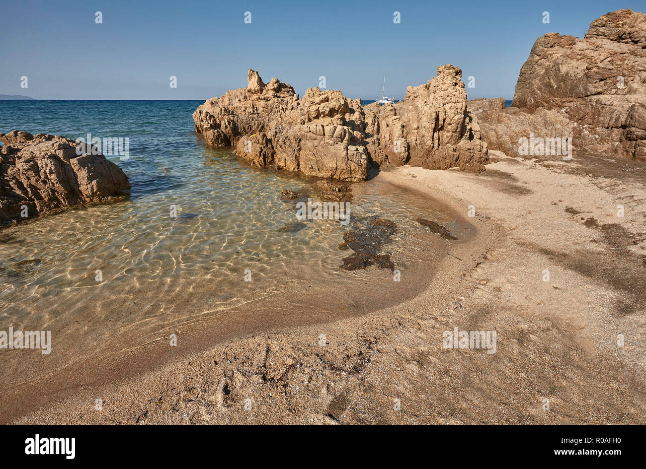 Rocks, crystal clear sea water and sun: the perfect symbol of a summer ...