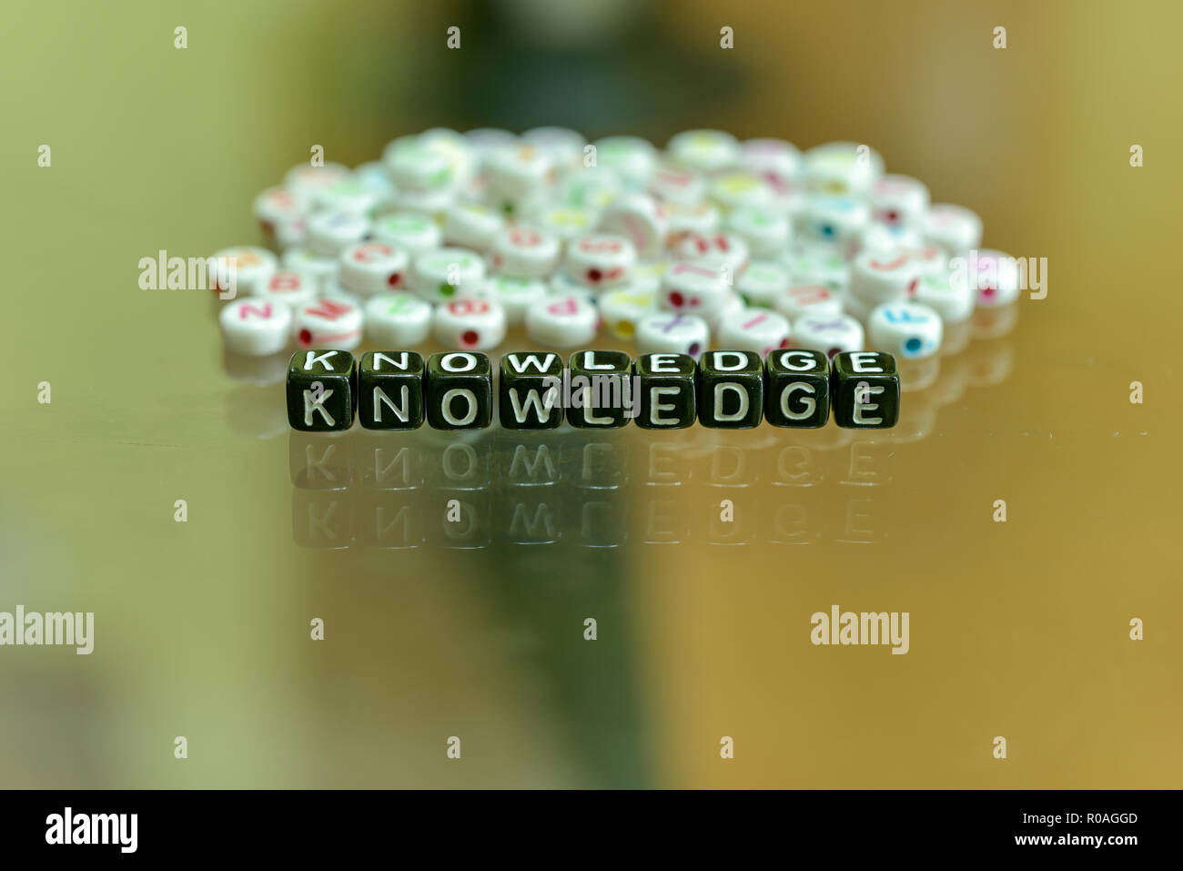 KNOWLEDGE written with Acrylic Black cube with white Alphabet Beads on ...