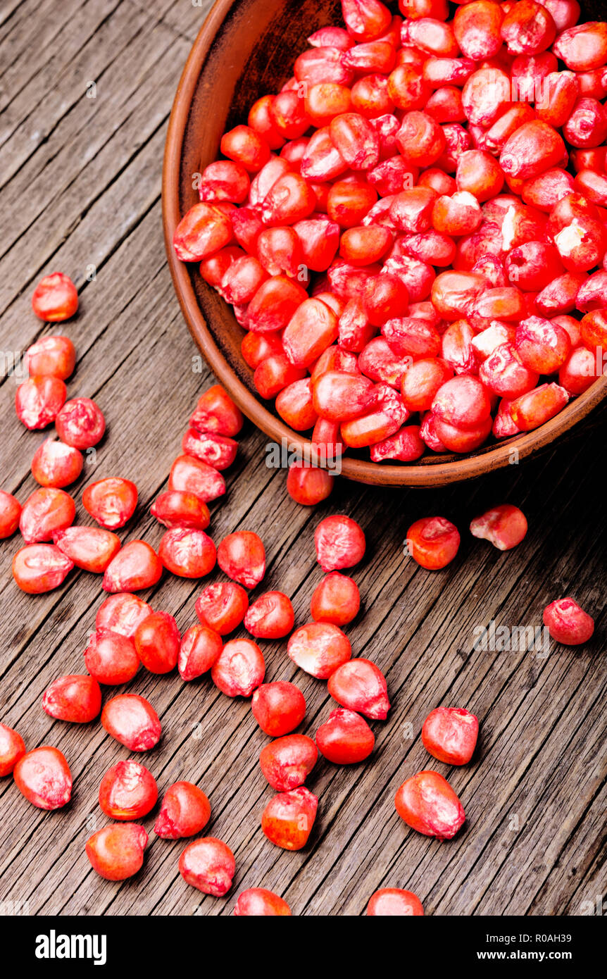 Red corn seeds.Painted dry corn grain in bowl Stock Photo - Alamy