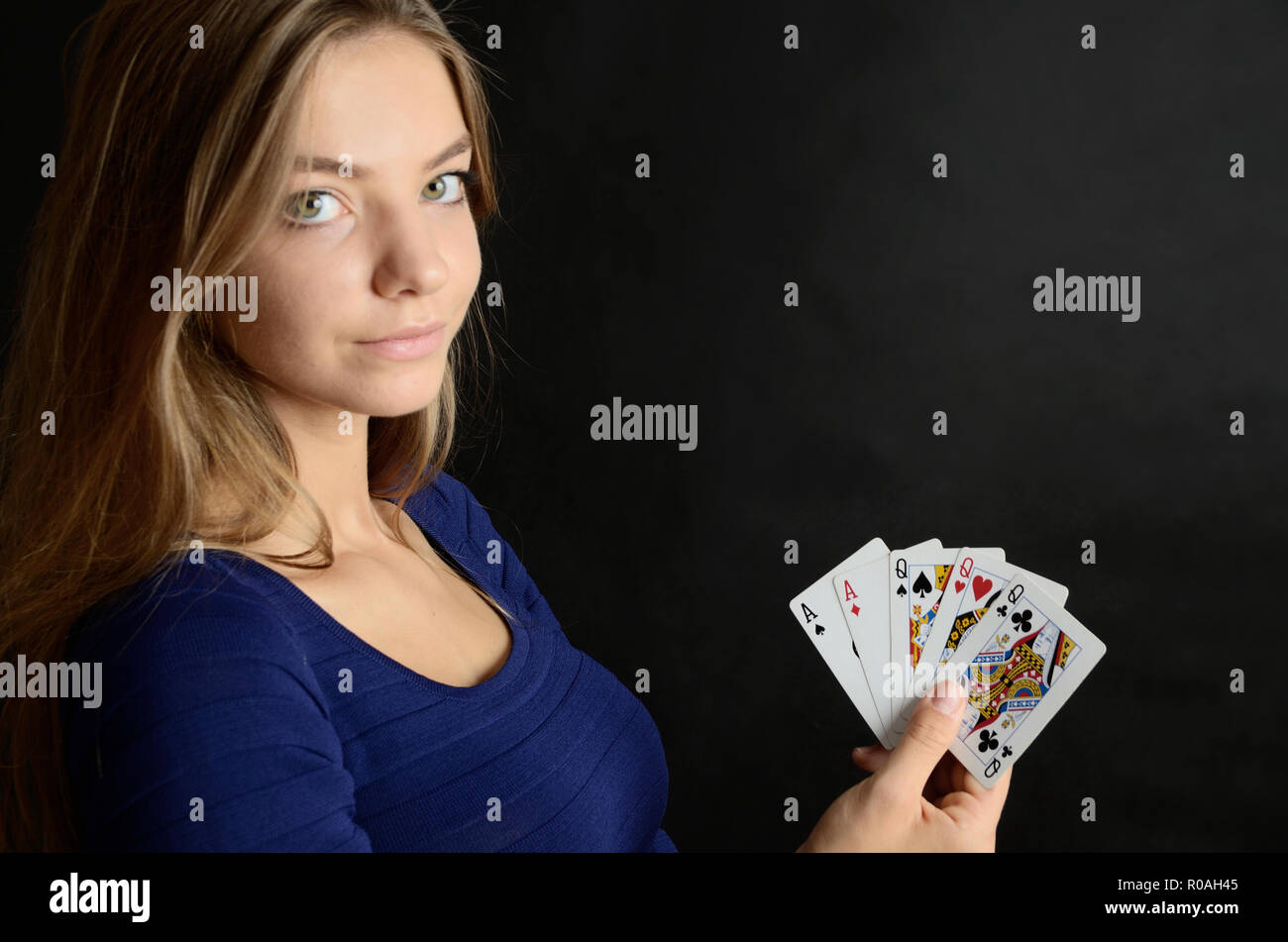 Young woman portrait with black background. Female model holding five ...