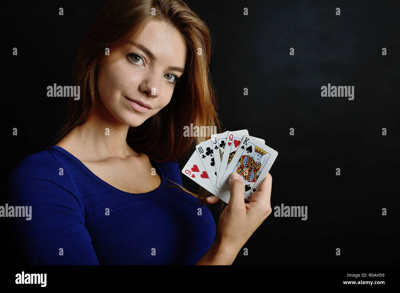 Young woman portrait with black background. Female model holding five ...