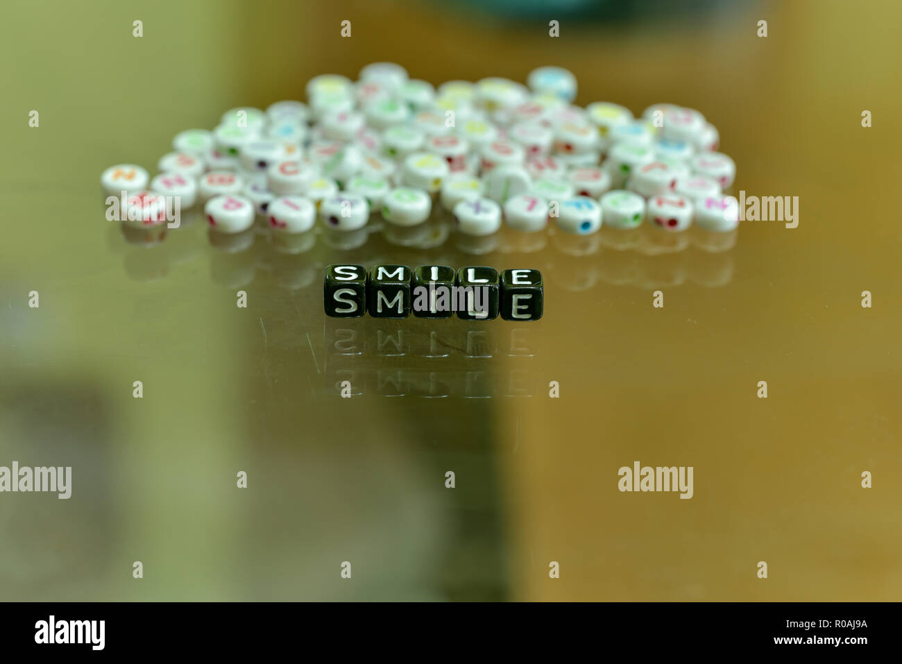 SMILE written with Acrylic Black cube with white Alphabet Beads on the ...