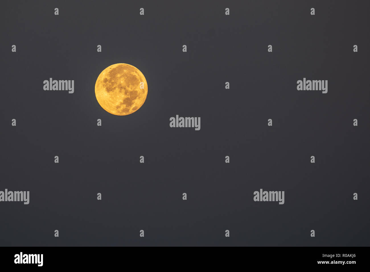 Orange full moon against dark sky, background Stock Photo - Alamy