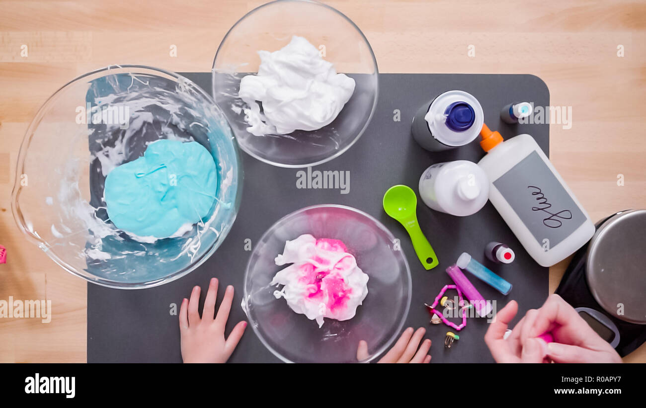 Step by step. Flat lay. Mother and daughter making colorful fluffy ...