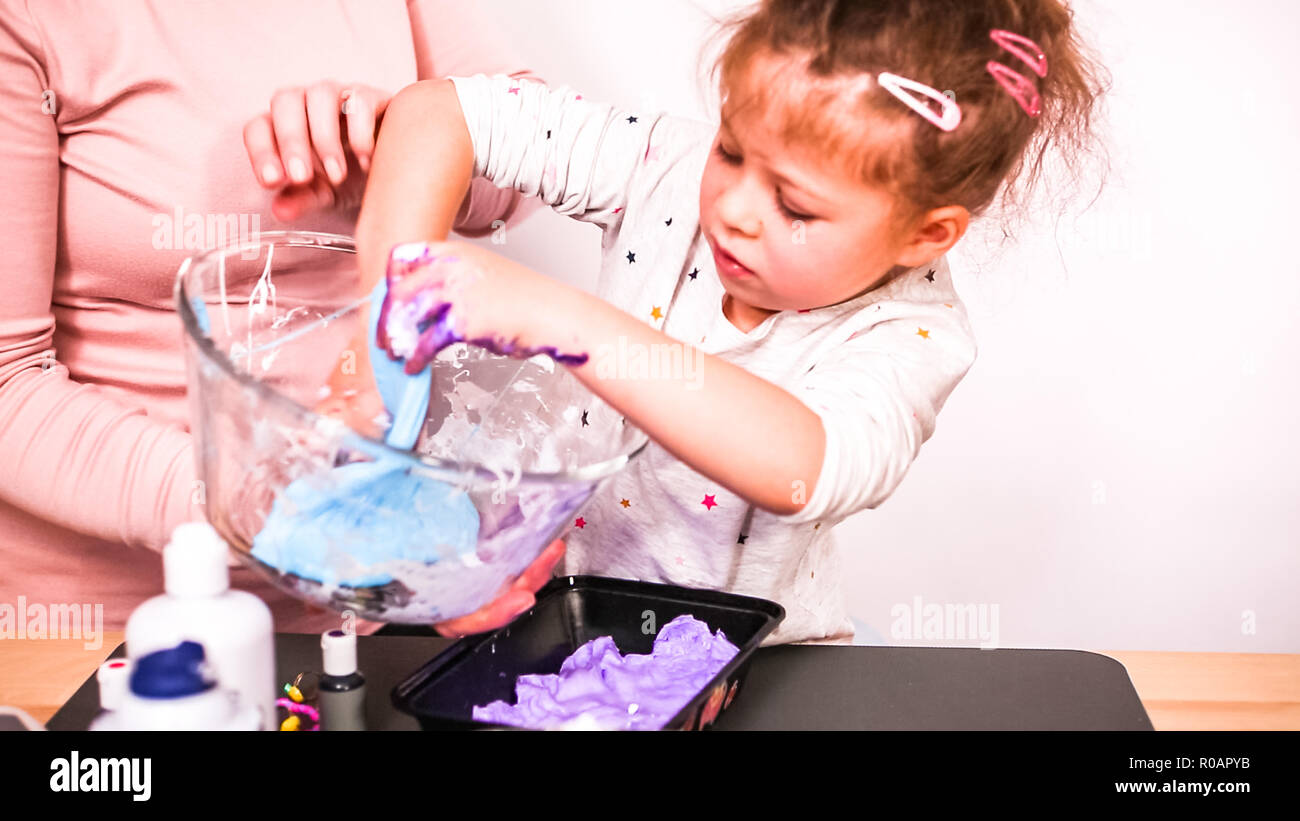 Step by step. Mother and daughter making colorful fluffy slime Stock ...