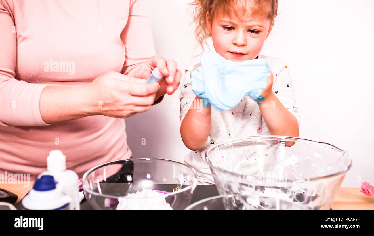 Step by step. Mother and daughter making colorful fluffy slime Stock ...