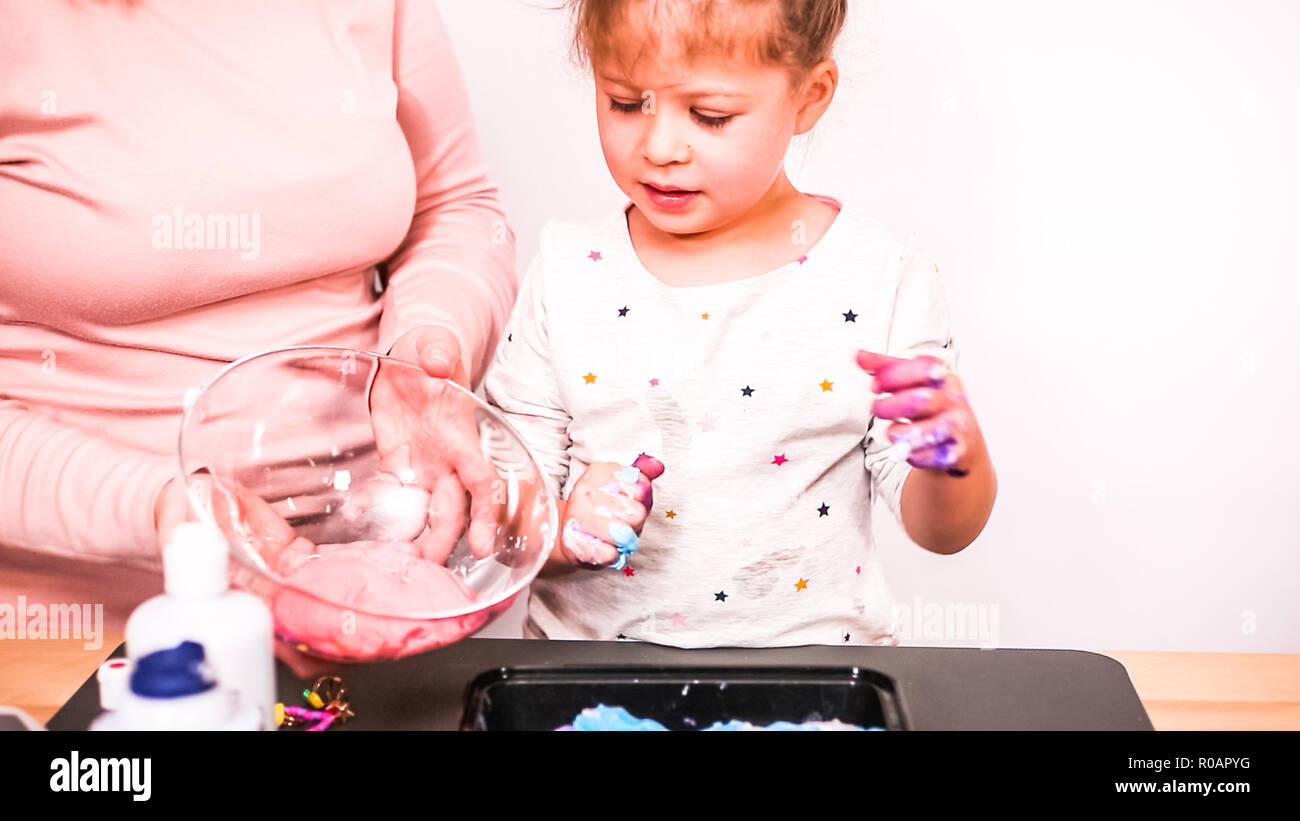 Step by step. Mother and daughter making colorful fluffy slime Stock ...
