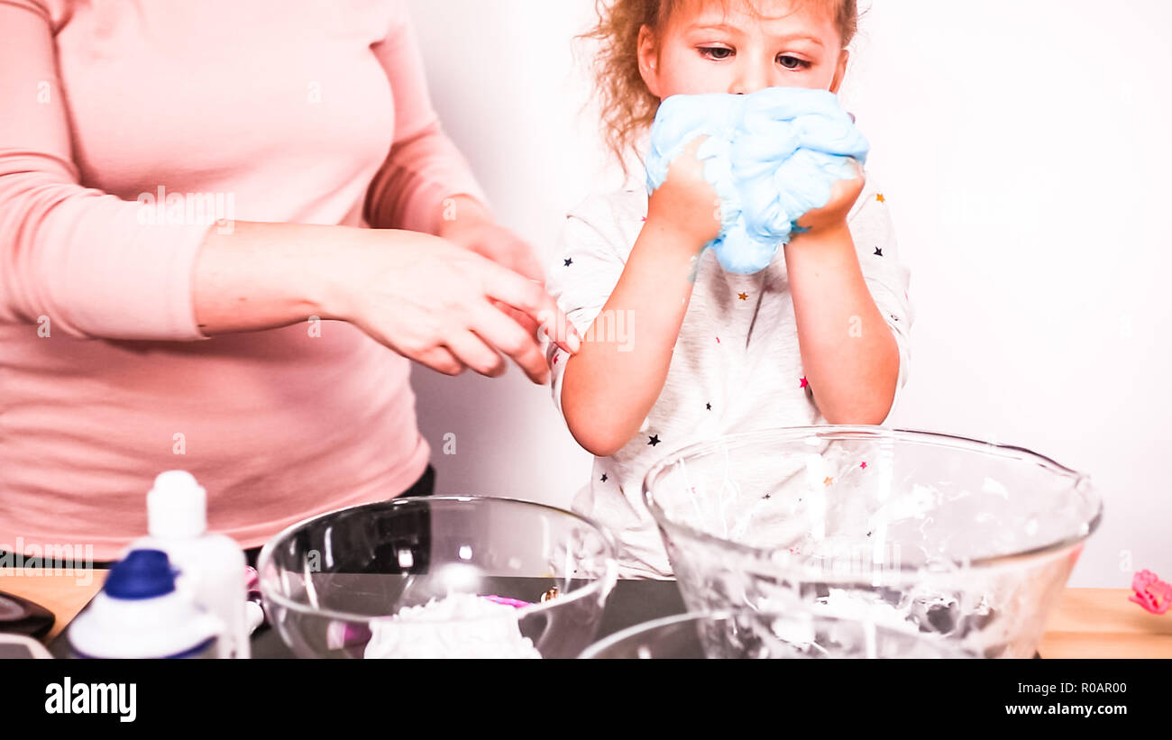 Step by step. Mother and daughter making colorful fluffy slime Stock ...