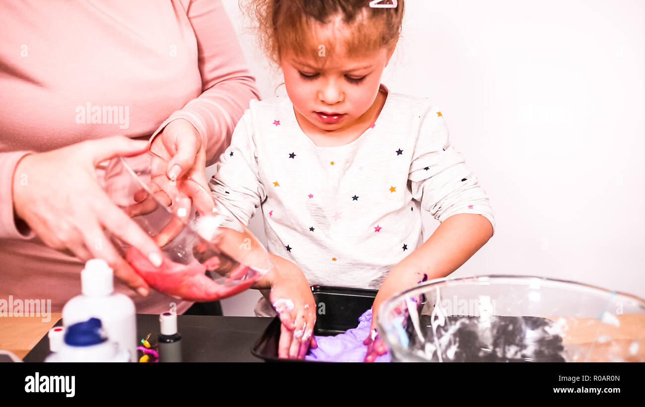 Step by step. Mother and daughter making colorful fluffy slime Stock ...