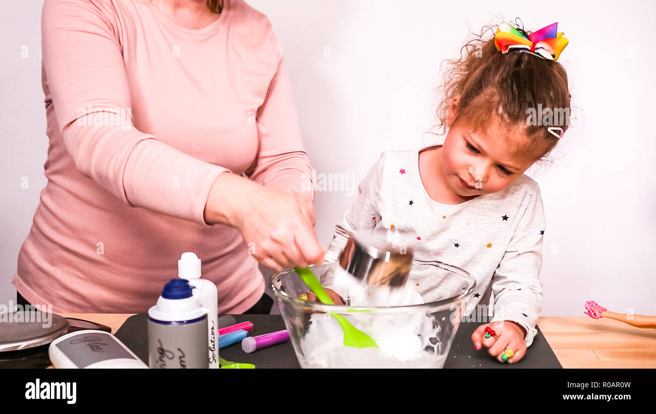 Step by step. Mother and daughter making colorful fluffy slime Stock ...