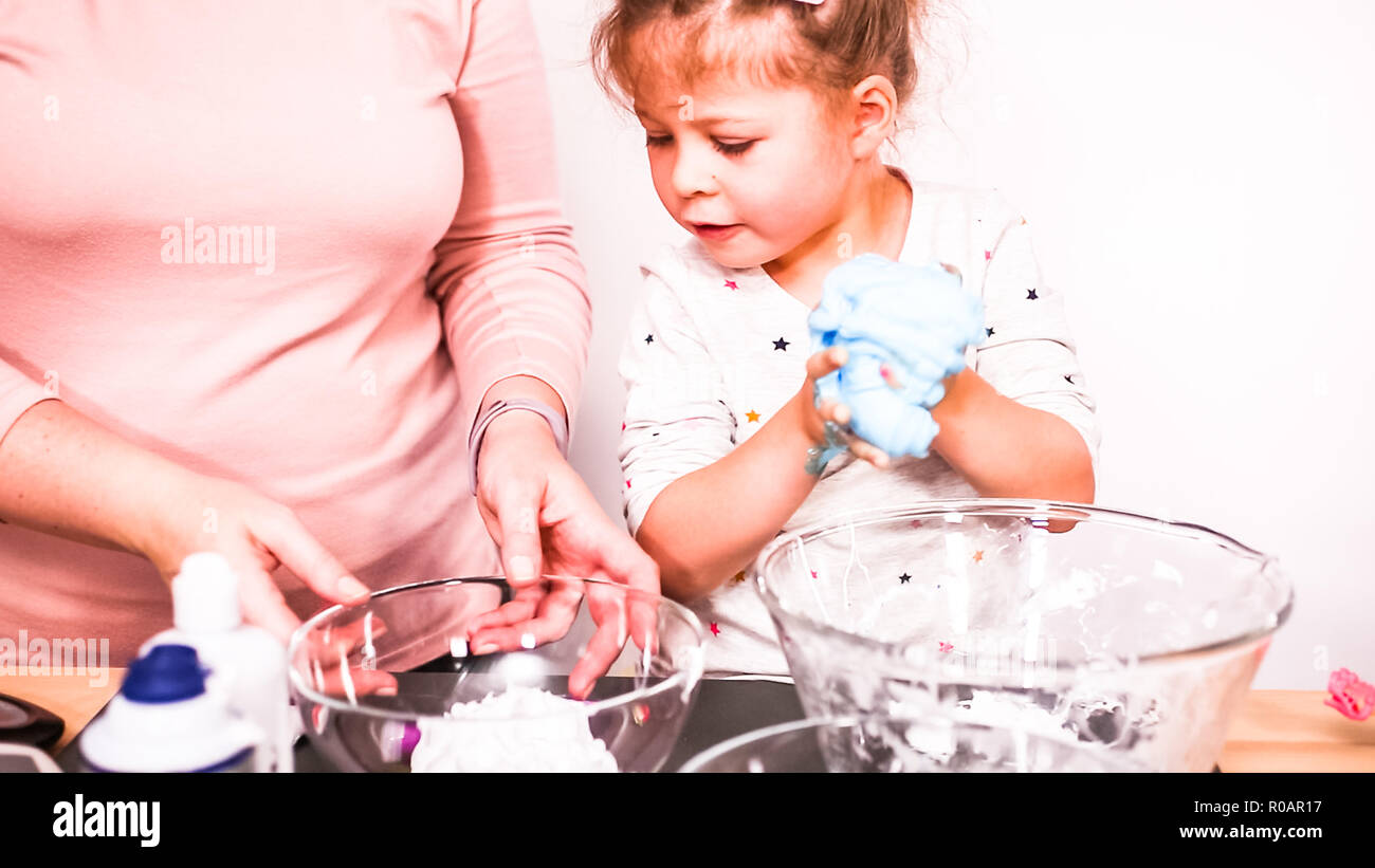 Step by step. Mother and daughter making colorful fluffy slime Stock ...