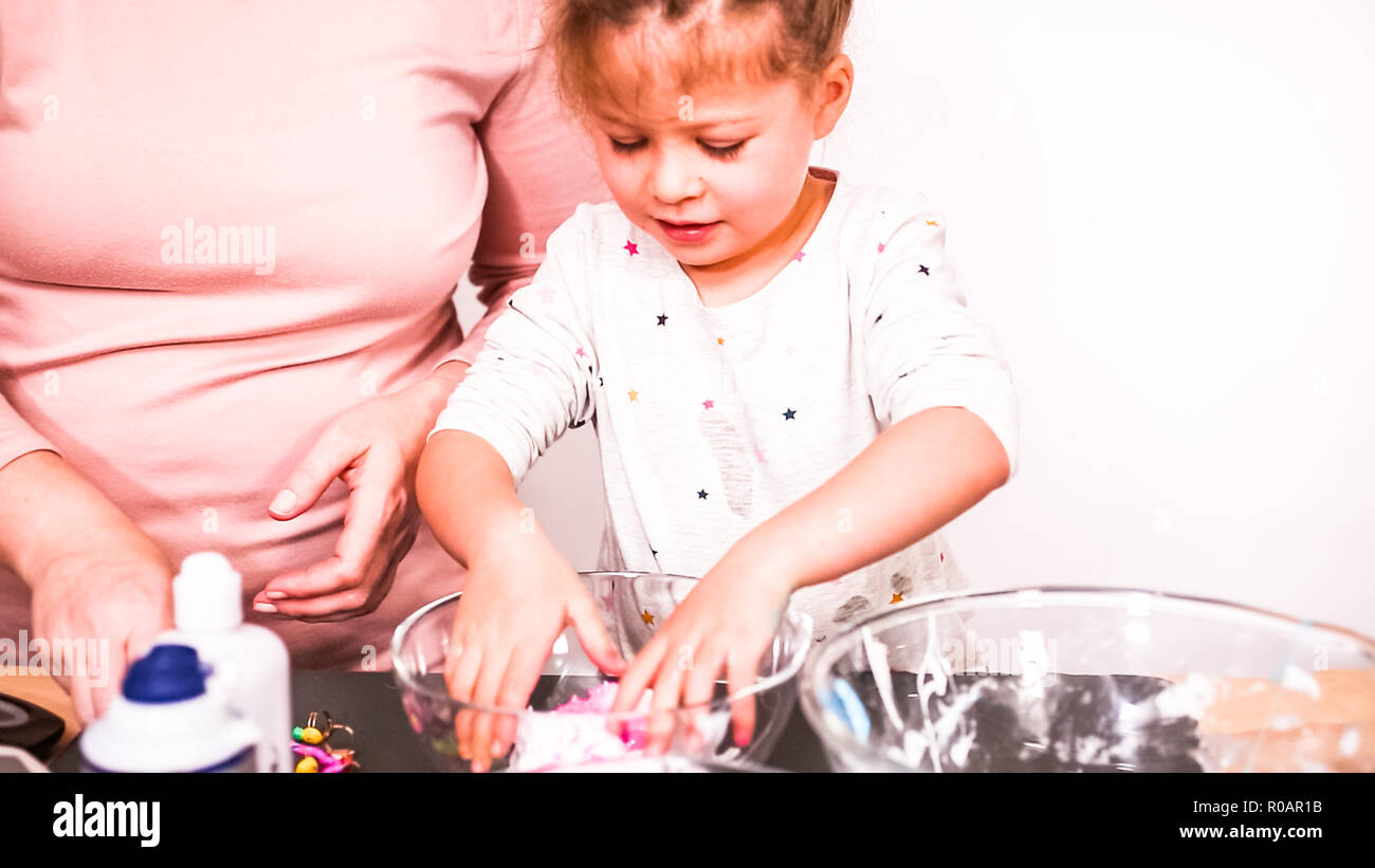 Step by step. Mother and daughter making colorful fluffy slime Stock ...