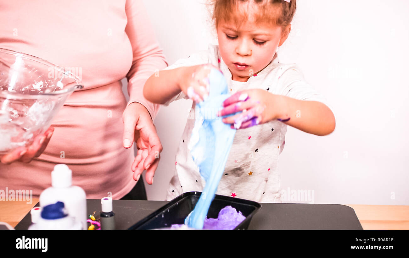 Step by step. Mother and daughter making colorful fluffy slime Stock ...